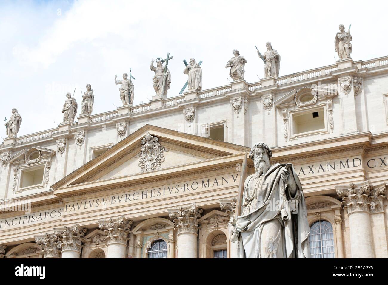 Statue of St. Paul with sword in front of St Peter's Basilica with blue ...