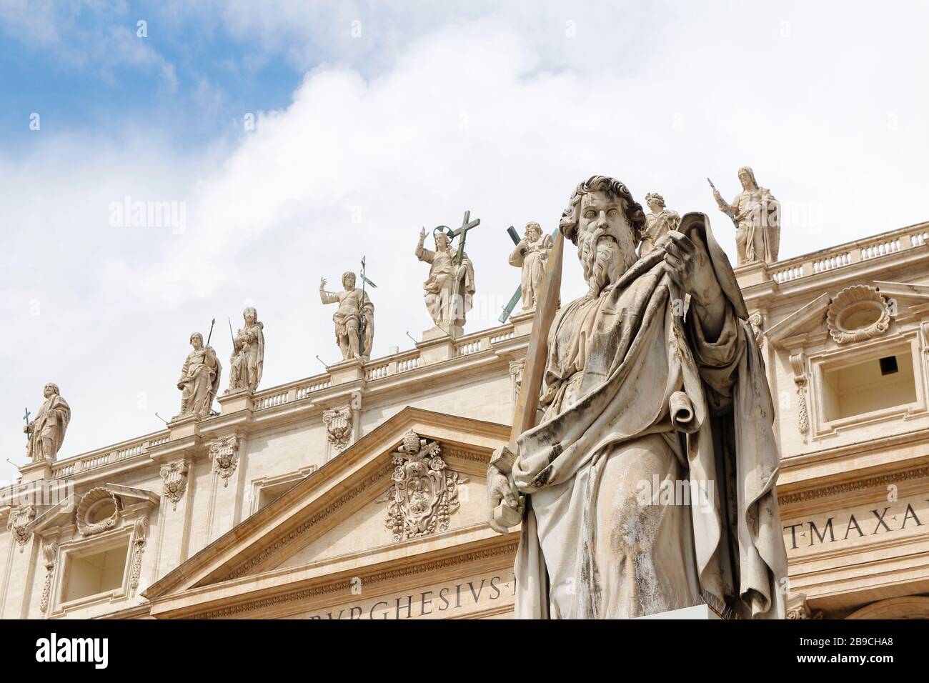 Statue of St. Paul with sword in front of St Peter's Basilica with blue ...