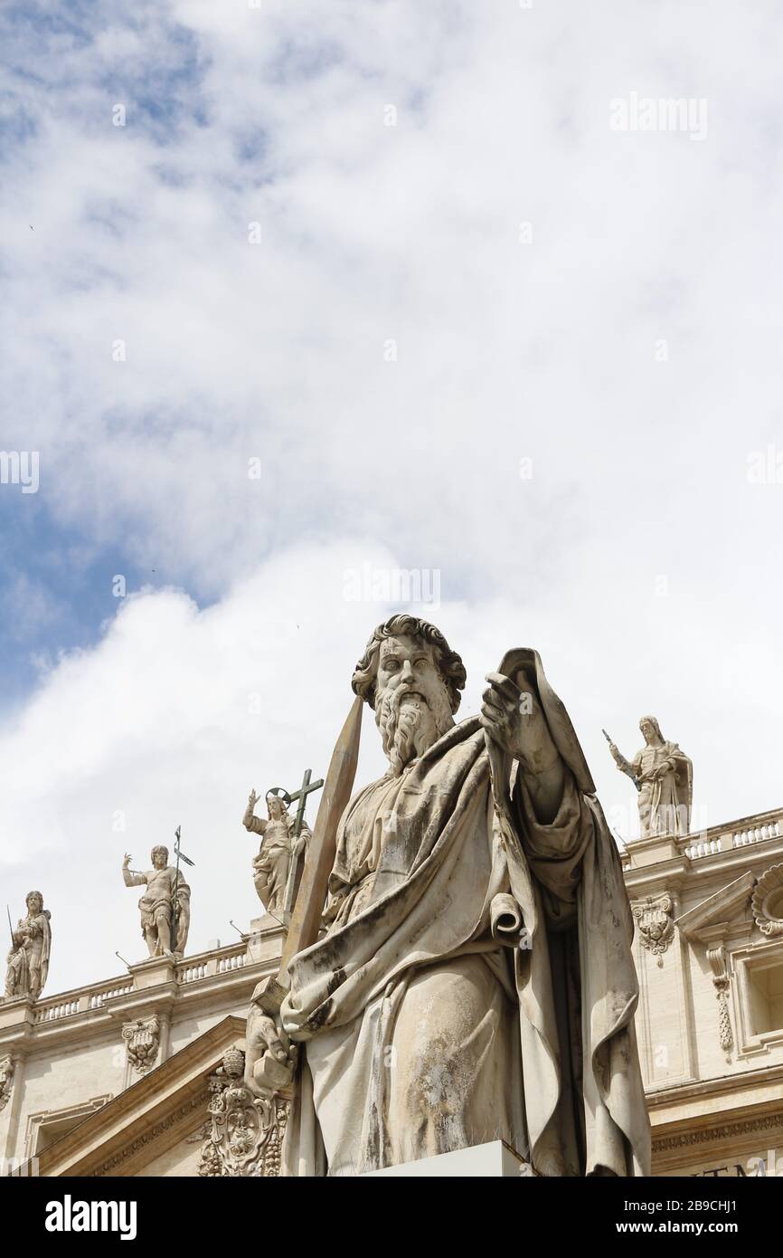 Statue of St. Paul with sword in front of St Peter's Basilica with blue ...