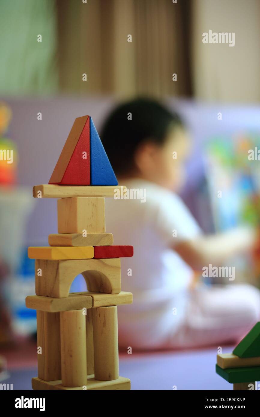 baby toy, wood blocks making into shape and form. blurred baby playing ...