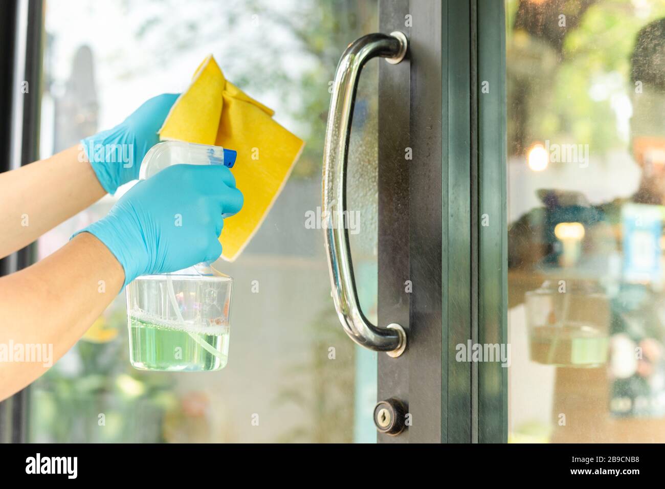 Mans hand with alcohol sanitizer door knob prevent the virus and ...