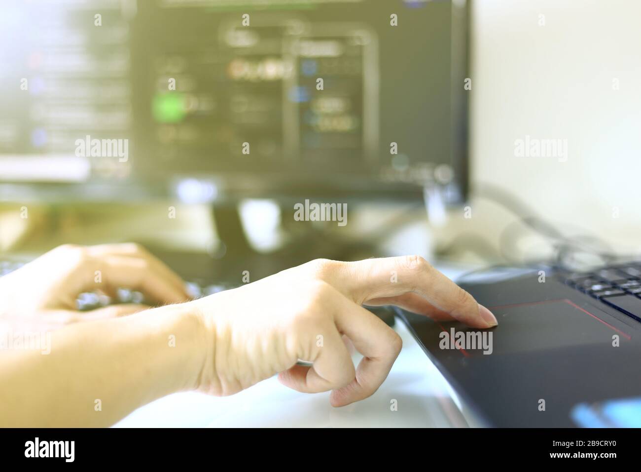 work at home concepts. man hand tracking on computer notebook track pad ...