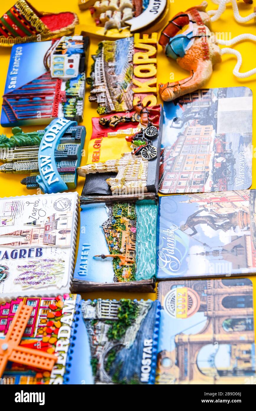 Magnets from different countries on yellow background, travel concept ...