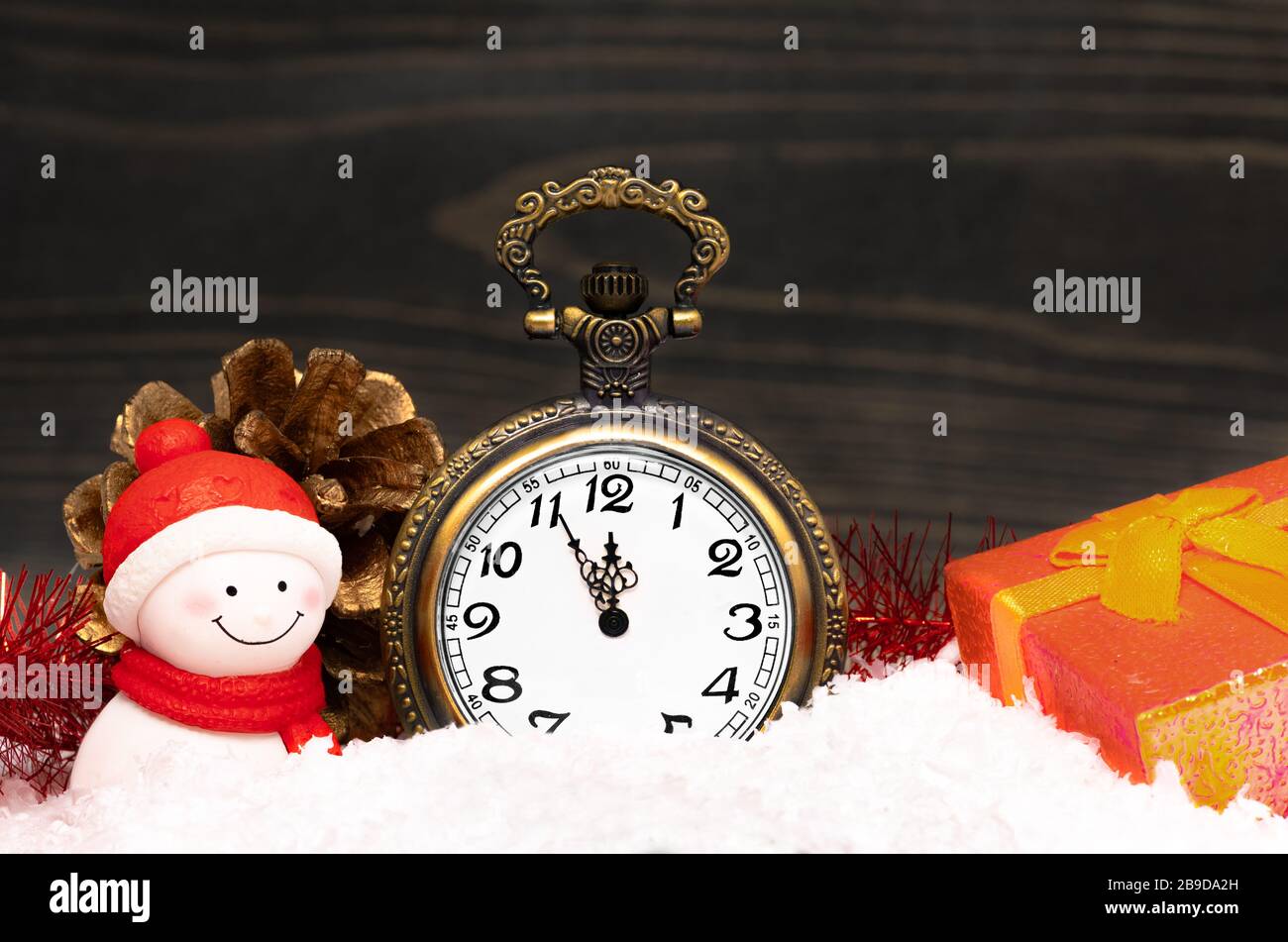 New Year clock. Decorated with snowman on snow wood background Stock ...