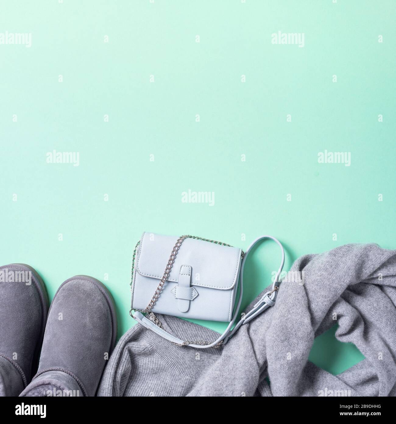 Fashion concept flat lay. Winter warm clothes flat lay on blue ...
