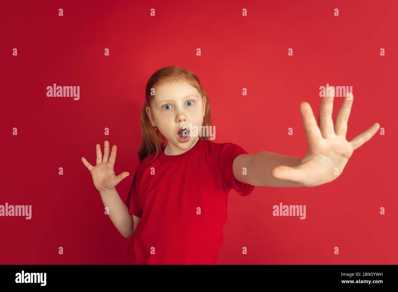 Trying to stop something. Caucasian little girl portrait isolated on ...