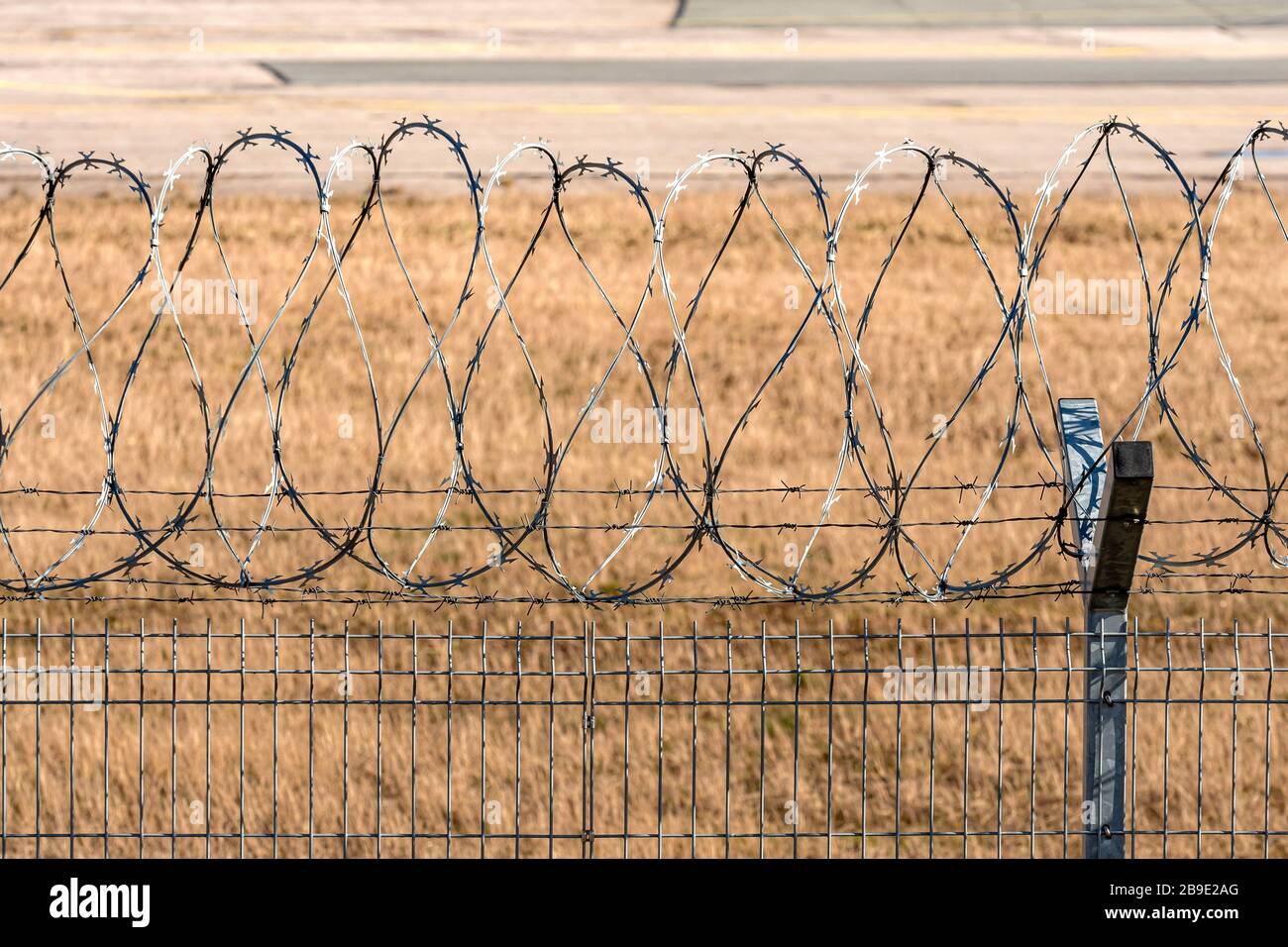 close-up of fence with barbed wire, security concept Stock Photo - Alamy