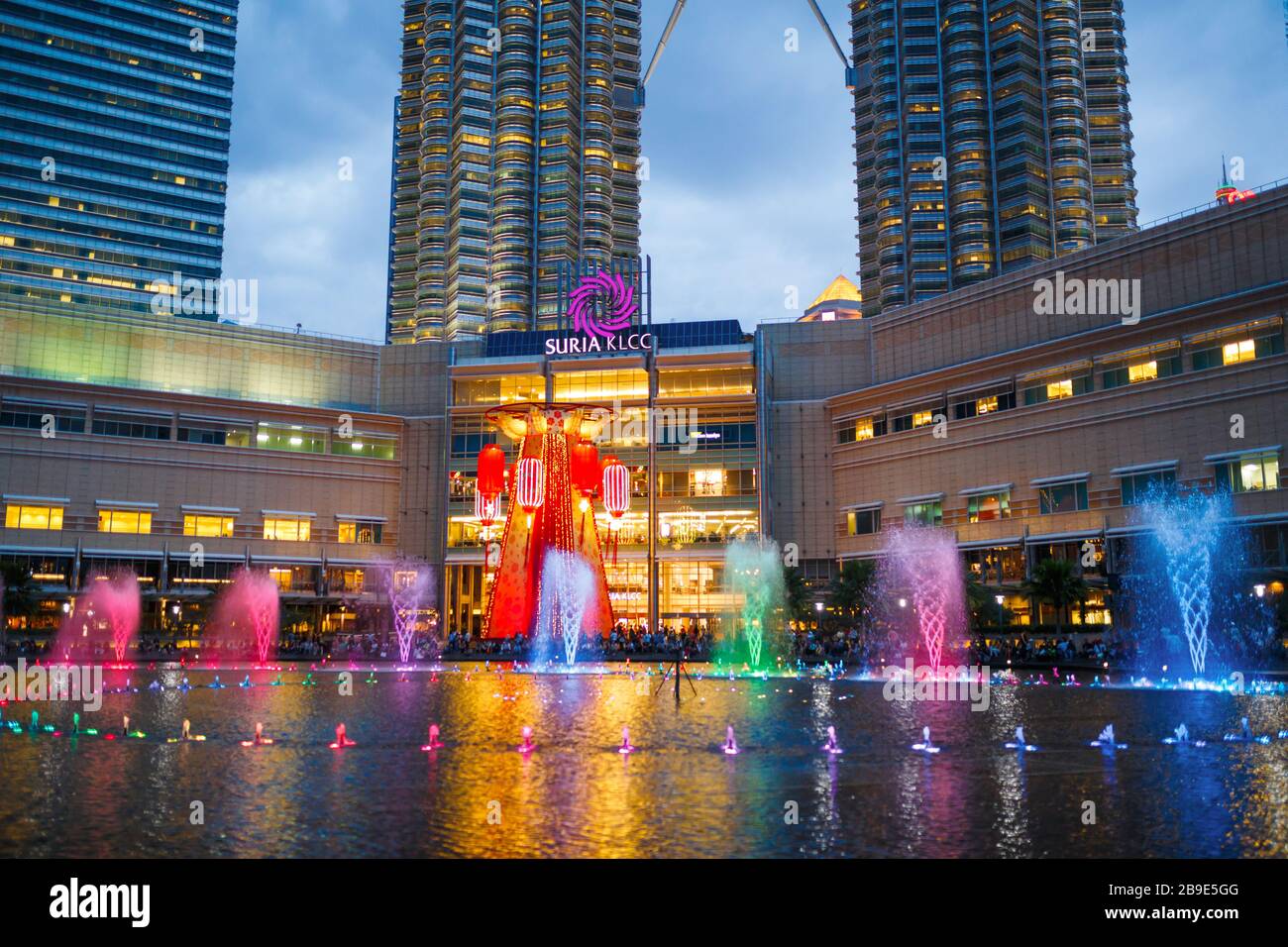 Multi-colored dancing fountains near the twin towers of Petronas in ...
