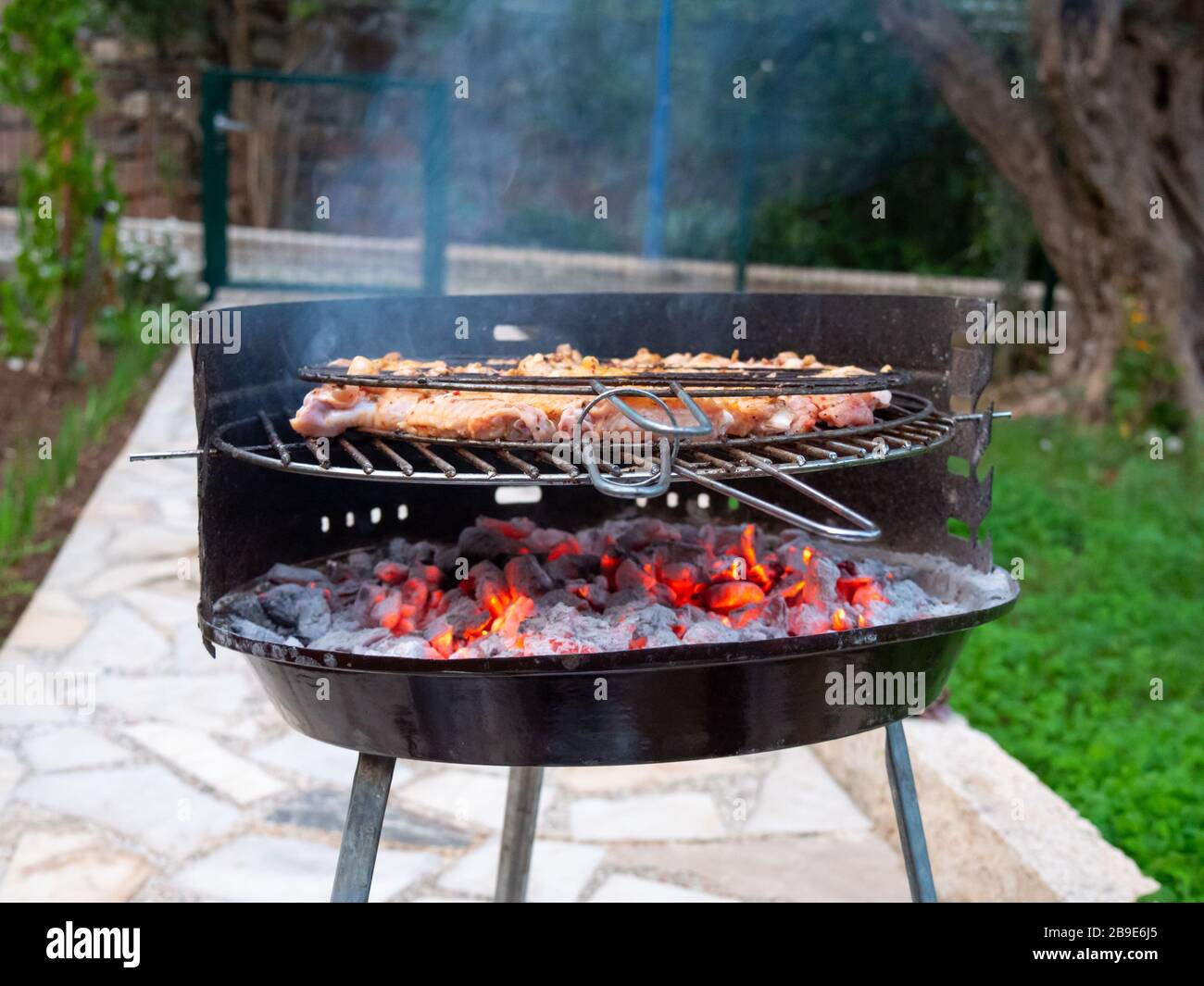 Grilled chicken legs on the flaming barbeque grill. food concept Stock ...