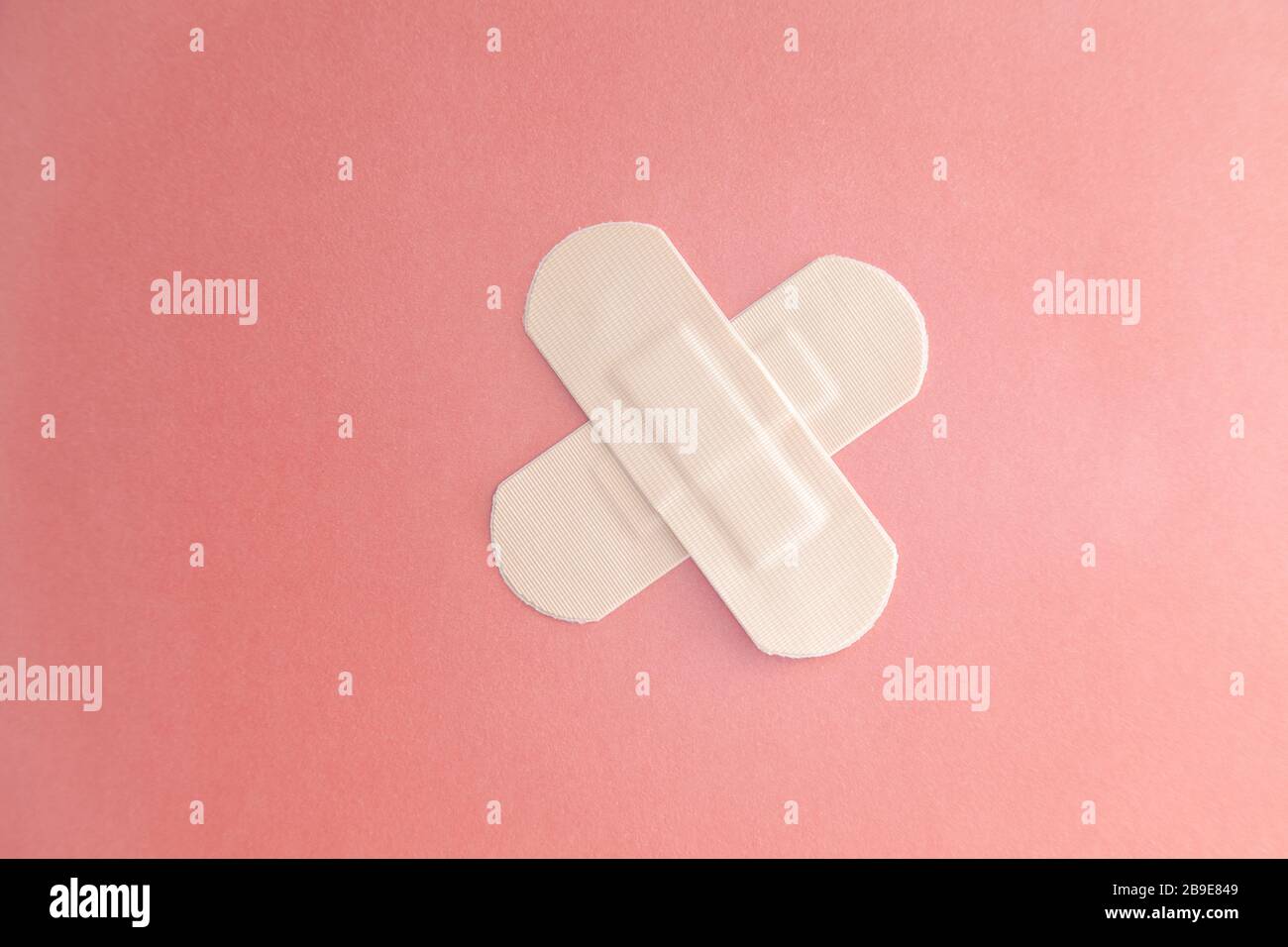 A stack of two adhesive plasters in shape of an X Stock Photo - Alamy
