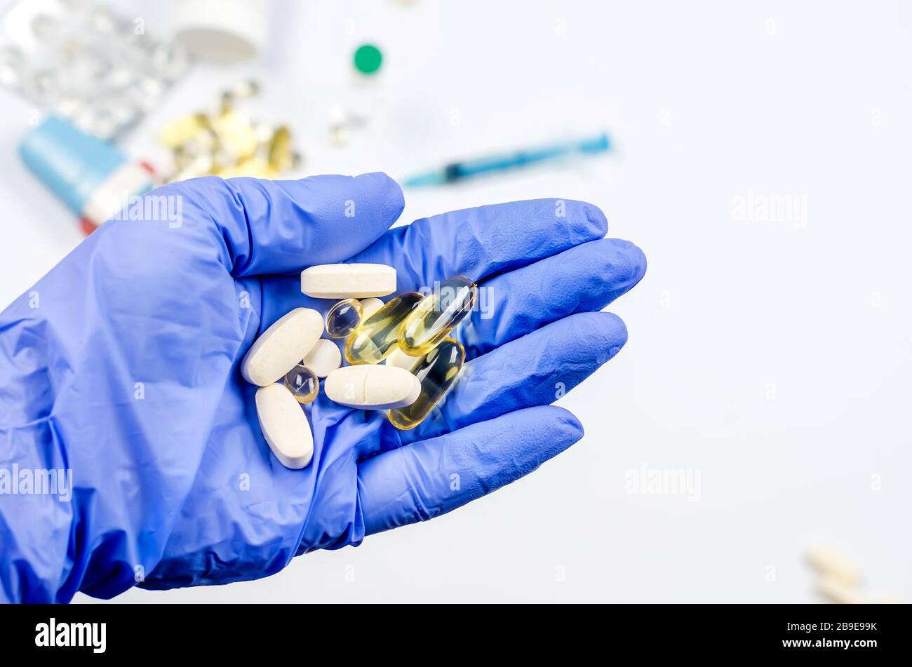 hand in gloves holding many pills Pharmaceutical medicine concept, copy ...