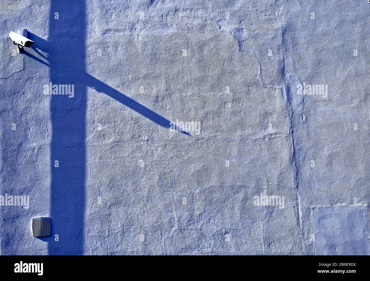 Security camera and shadow against white painted textured wall Stock ...