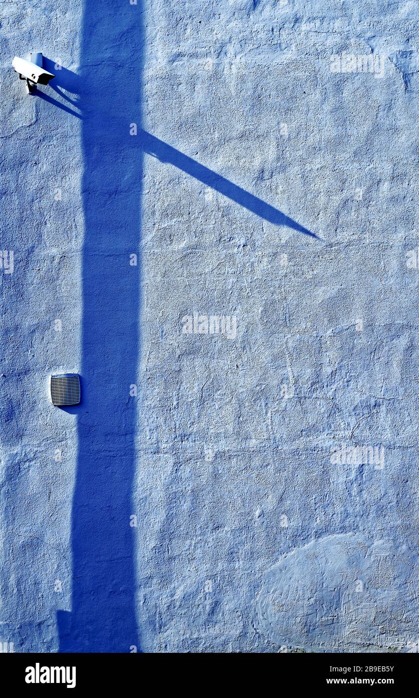 Security camera and shadow against white painted wall Stock Photo - Alamy