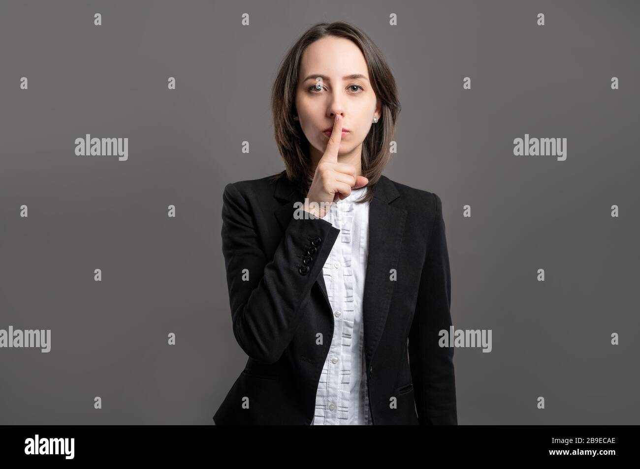 Portrait of wonderful young business woman wering black suit and shirt ...