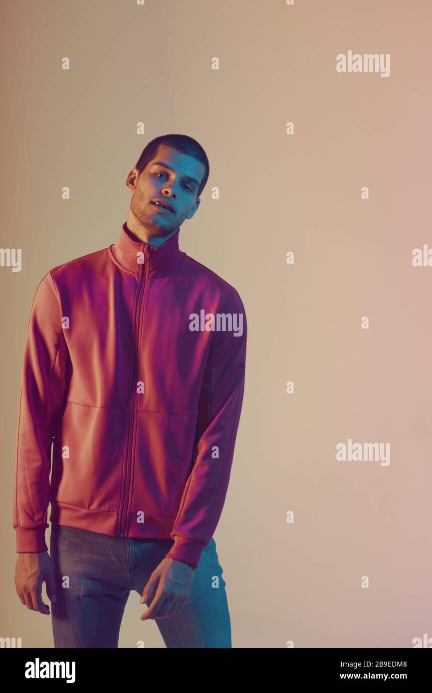 Close-up portrait of attractive male model. Retro wave portrait of a ...