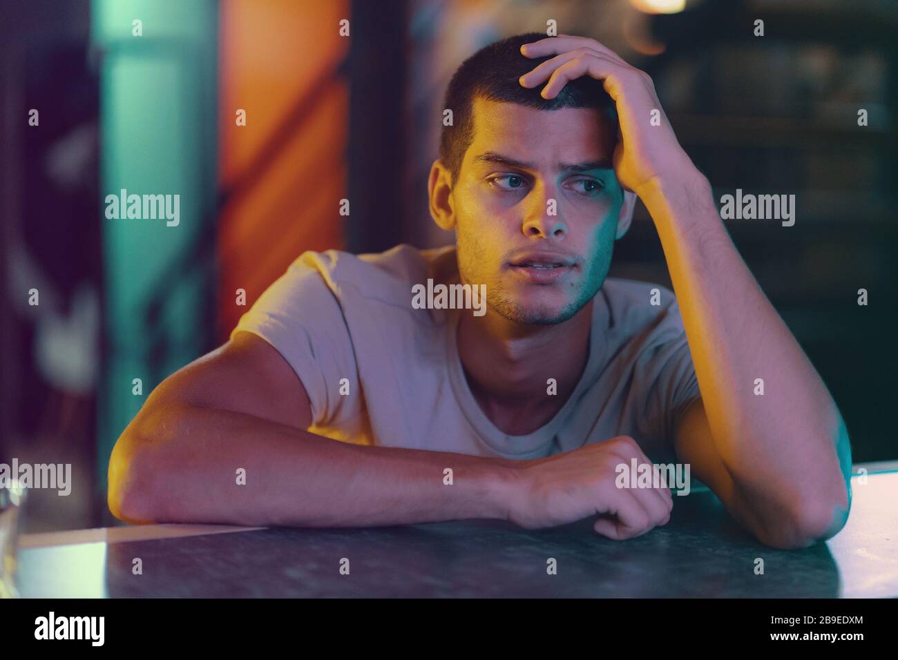 Close-up portrait of attractive male model. Retro wave portrait of a ...