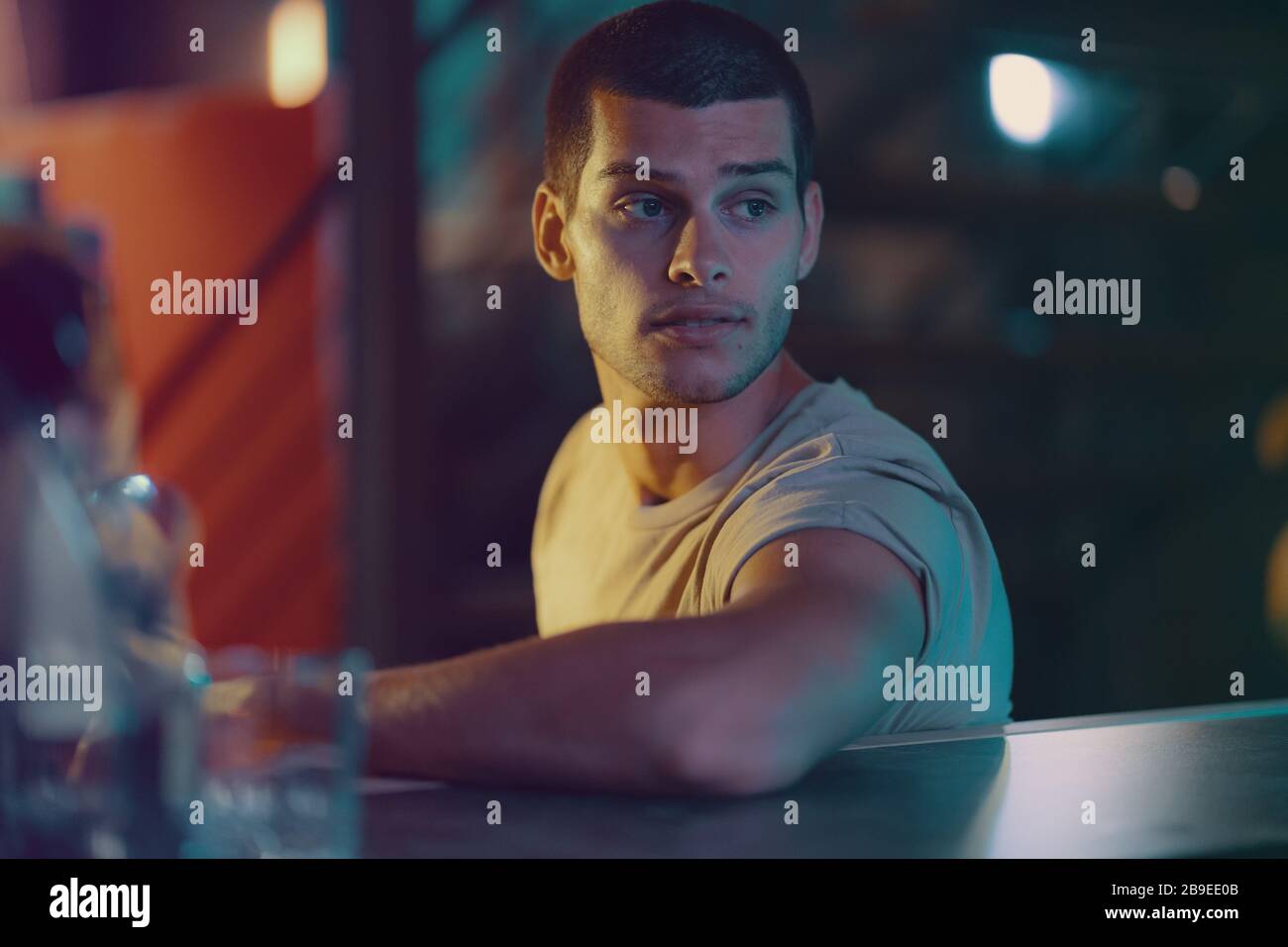 Close-up portrait of attractive male model. Retro wave portrait of a ...