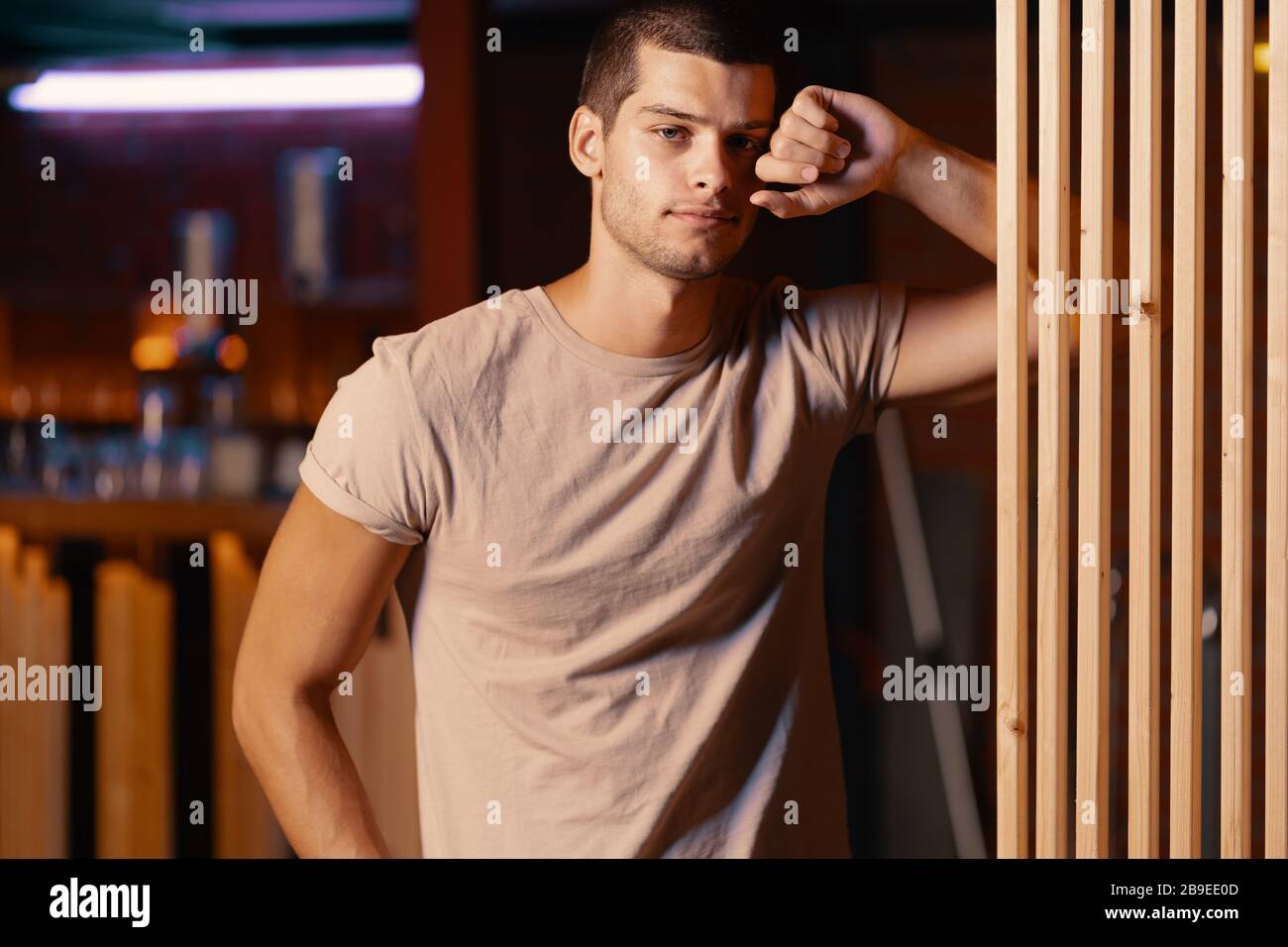 Close-up portrait of attractive male model. Retro wave portrait of a ...