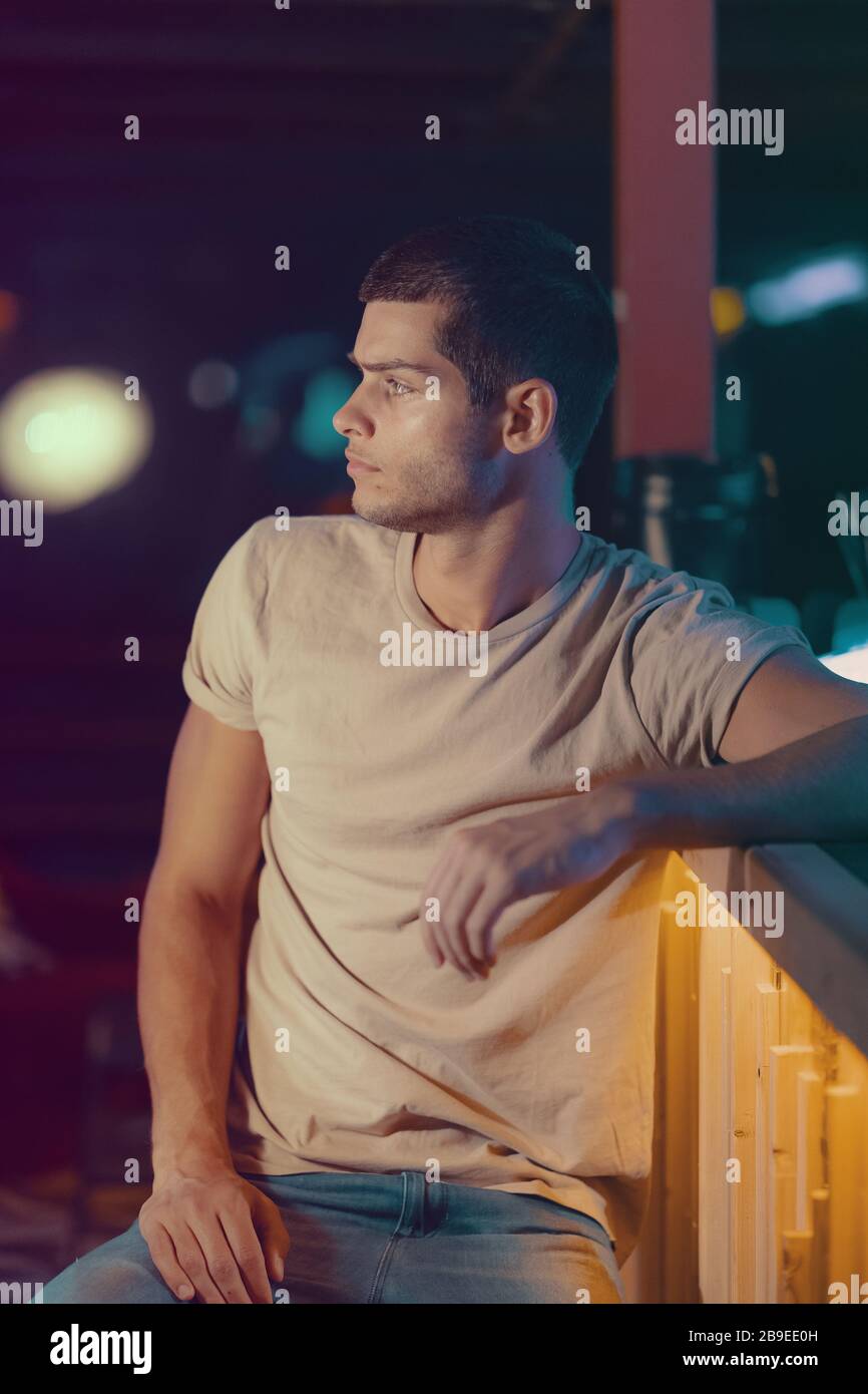 Close-up portrait of attractive male model. Retro wave portrait of a ...