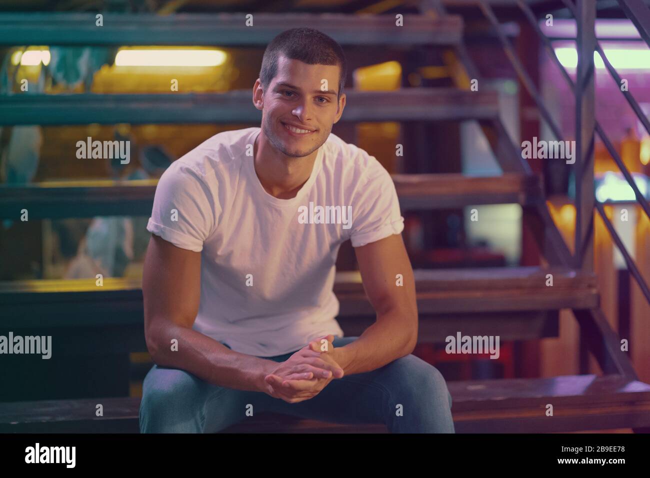 Close-up portrait of attractive male model. Retro wave portrait of a ...