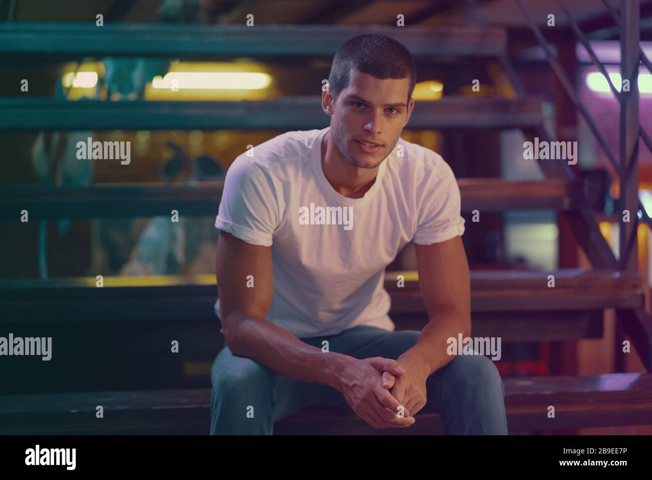 Close-up portrait of attractive male model. Retro wave portrait of a ...