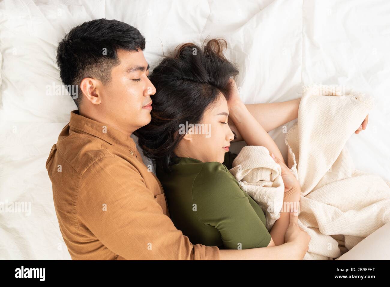 Asian couple sleeping in bed hi-res stock photography and images - Alamy