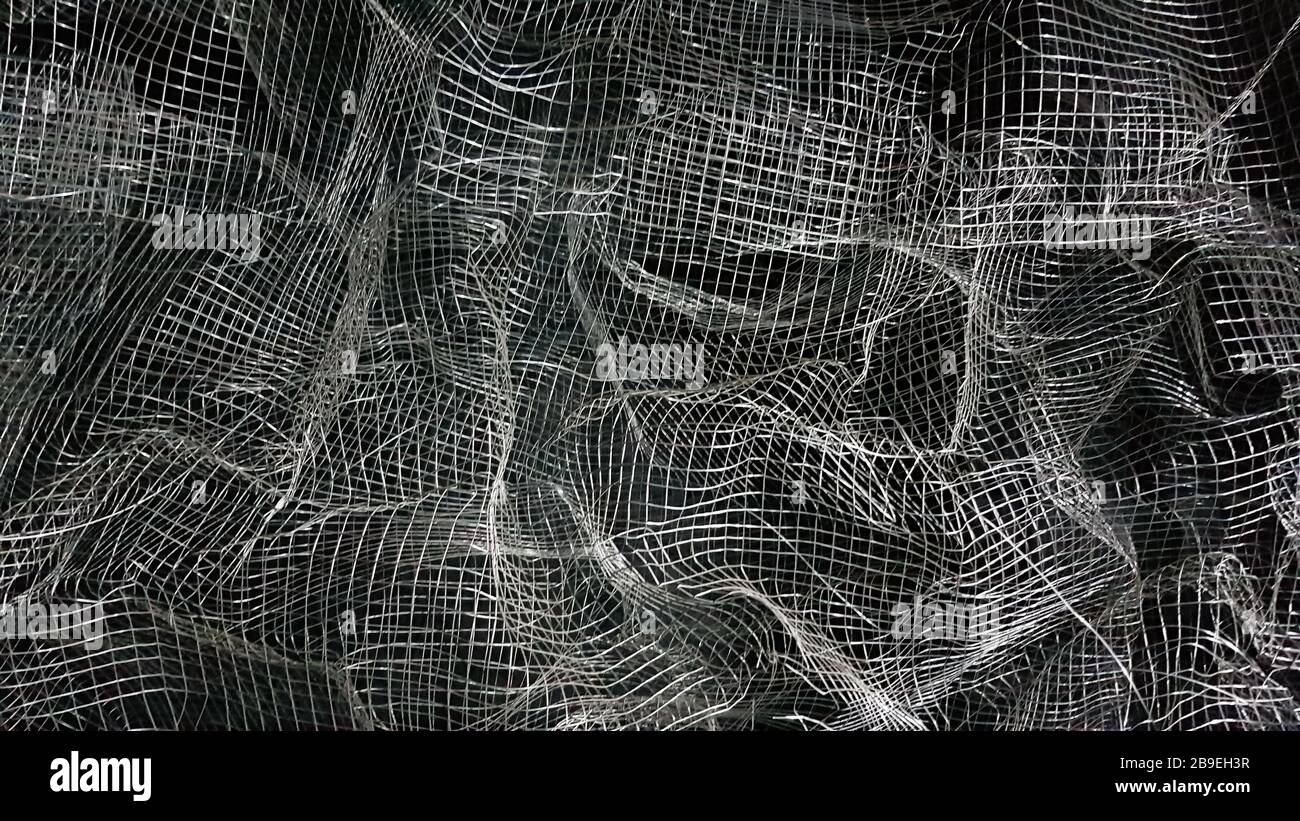 Crumpled mesh. Abstract background. Metal mesh with shadow on a black ...
