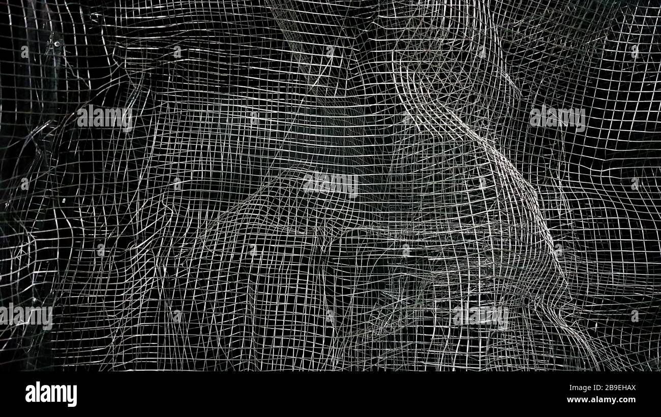 Crumpled mesh. Abstract background. Metal mesh with shadow on a black ...