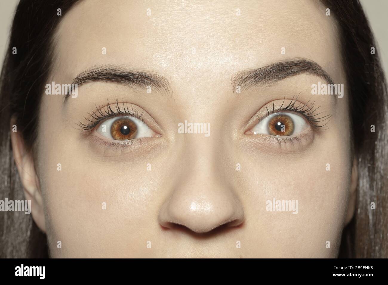 Wondered. Close up of face of beautiful caucasian young woman, focus on ...