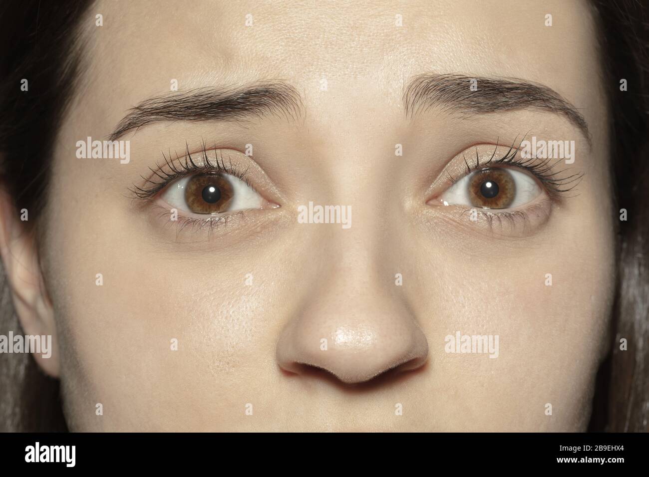 Sad, scared. Close up of face of beautiful caucasian young woman, focus ...