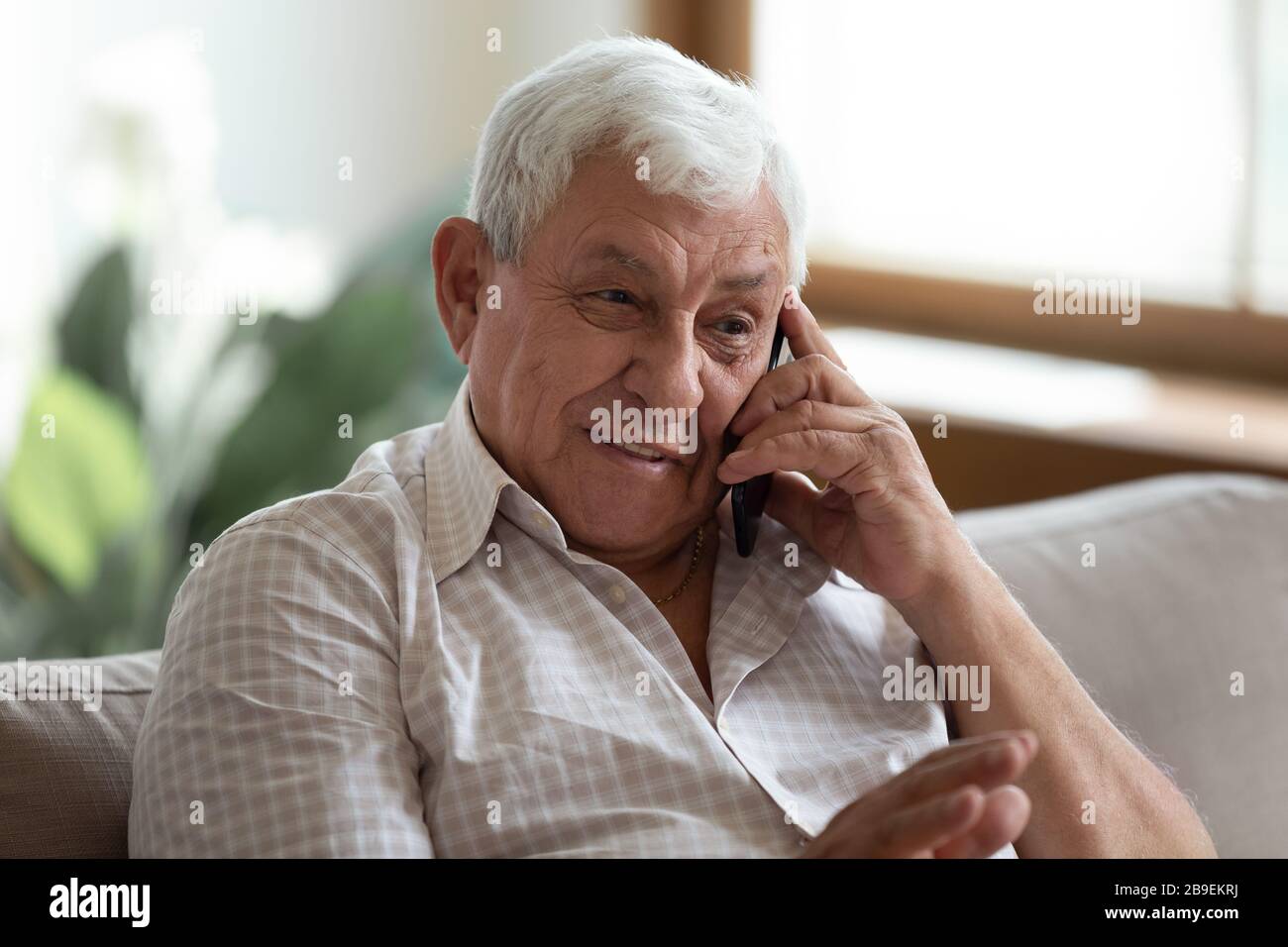Smiling older man talking on phone, chatting with relatives Stock Photo ...