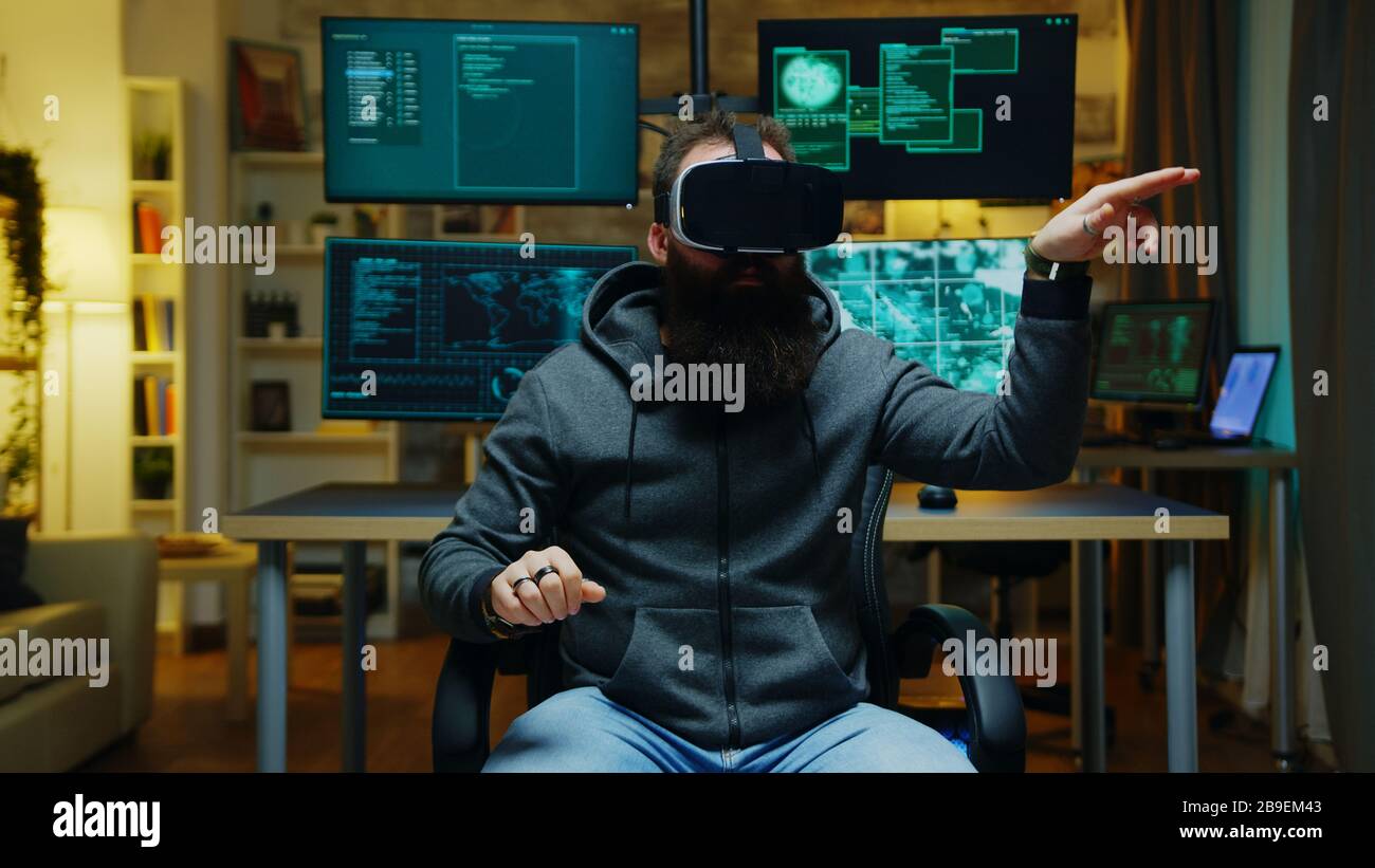 Bearded hacker wearing a virtual reality goggles. Internet criminal ...