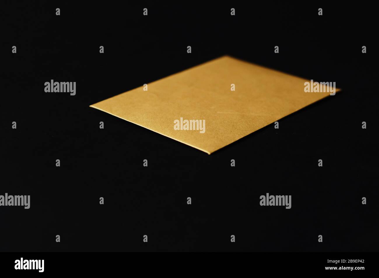 Blank golden paper card on black background, premium business and ...