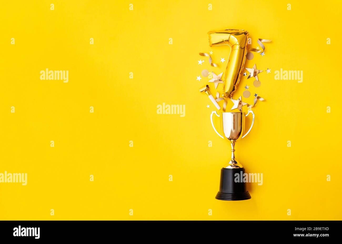 Number 7 gold anniversary celebration balloon exploding from a winning ...