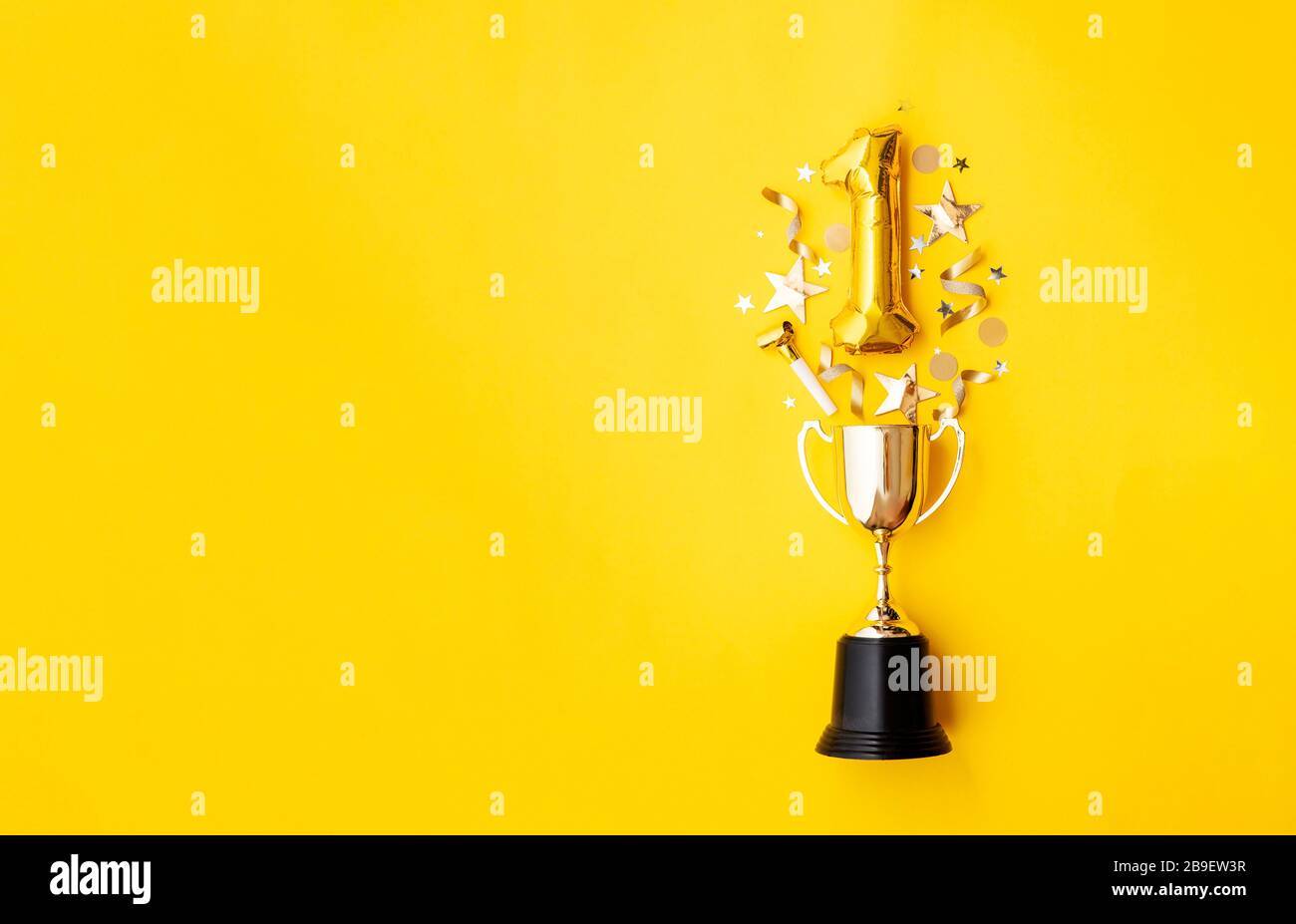 Number 1 gold anniversary celebration balloon exploding from a winning ...