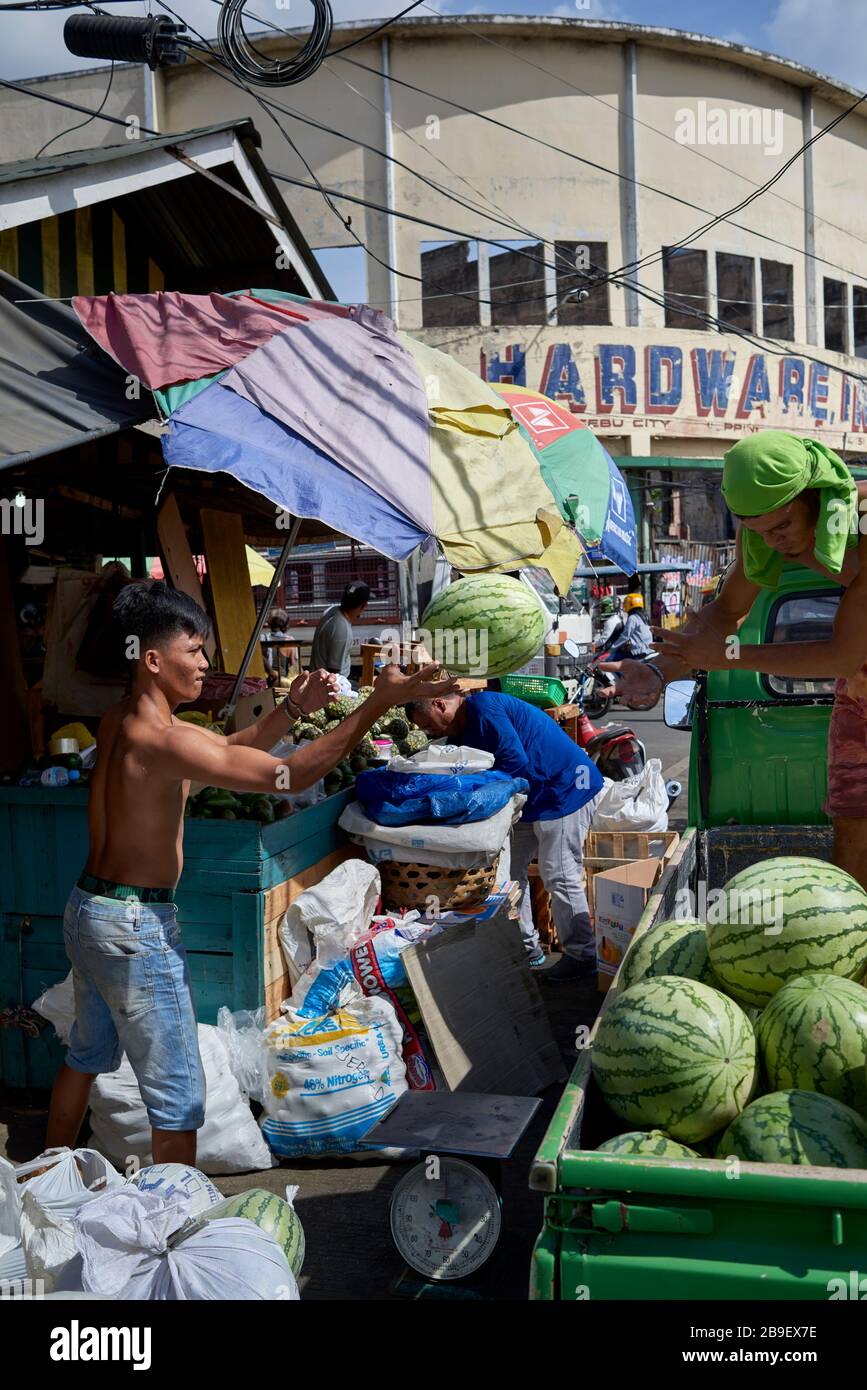 Porters loading a truck of watermelons in the streets of the Carbon ...