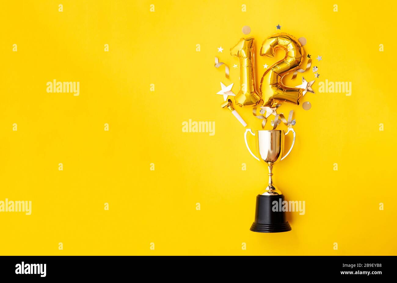 Number 12 gold anniversary celebration balloon exploding from a winning ...