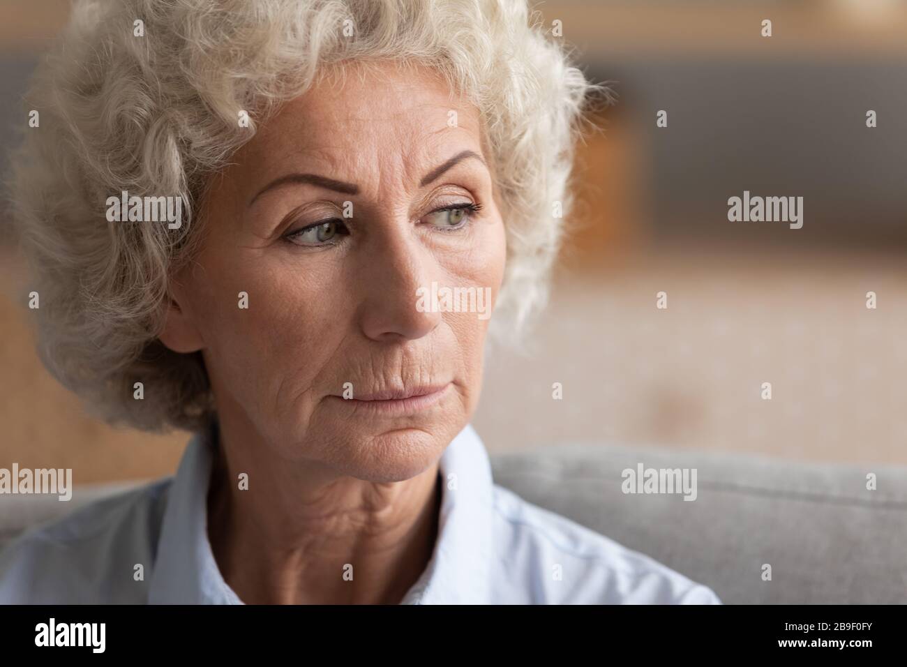 Sad senior woman look in distance feeling melancholic Stock Photo - Alamy
