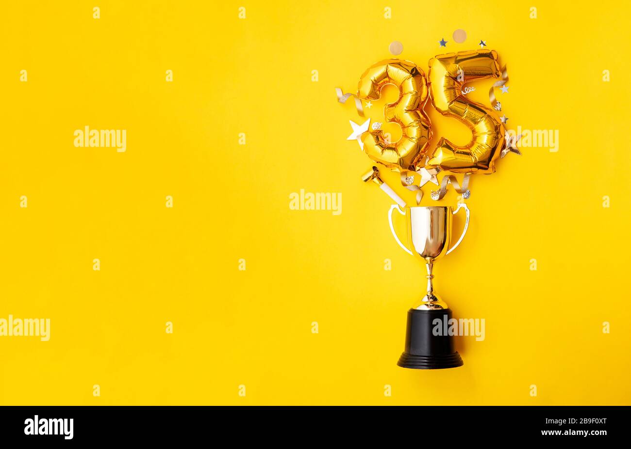 Number 35 gold anniversary celebration balloon exploding from a winning ...