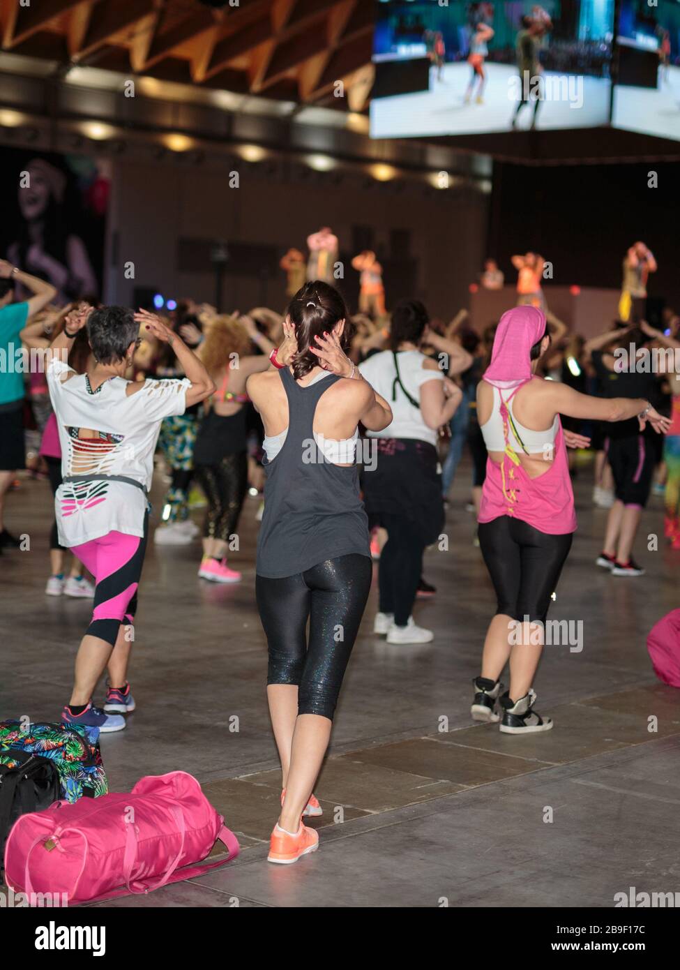 Fitness Workout in Gym: People doing Exercises in Class with Music and ...