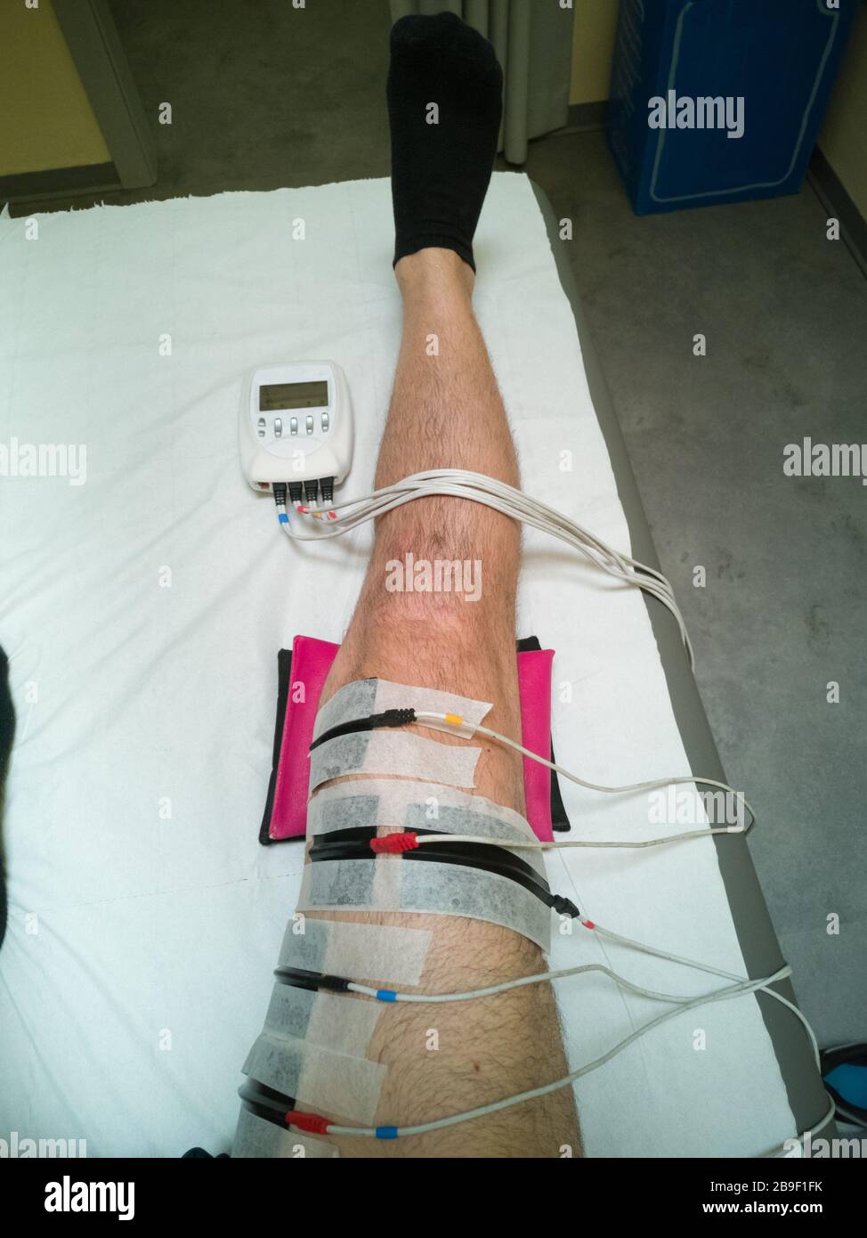 Human Leg with Muscles Electrostimulation Device and Ice Bag during ...