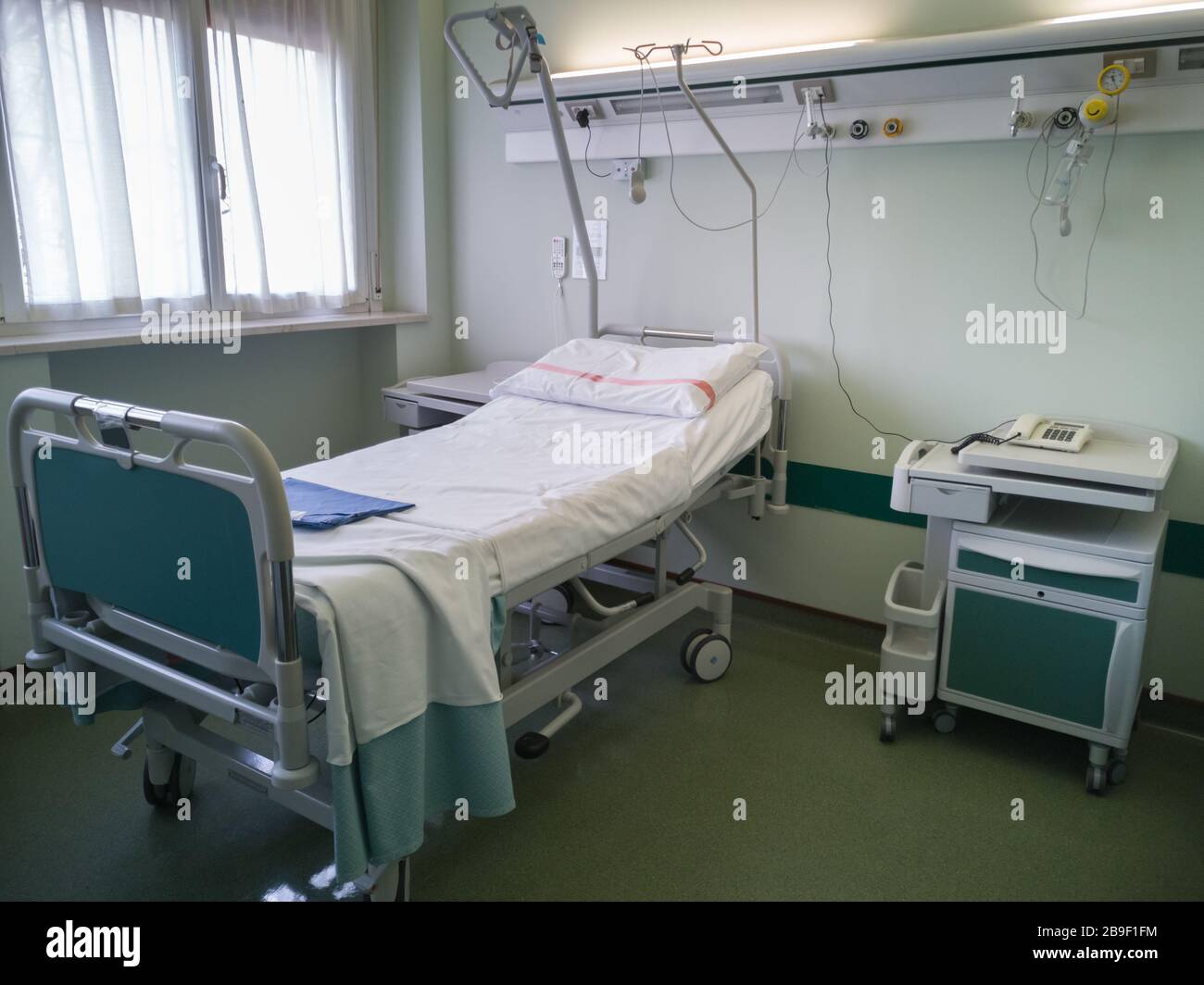 Empty Hospital Clinic Room with Bed, Drawer unit and Window Stock Photo ...