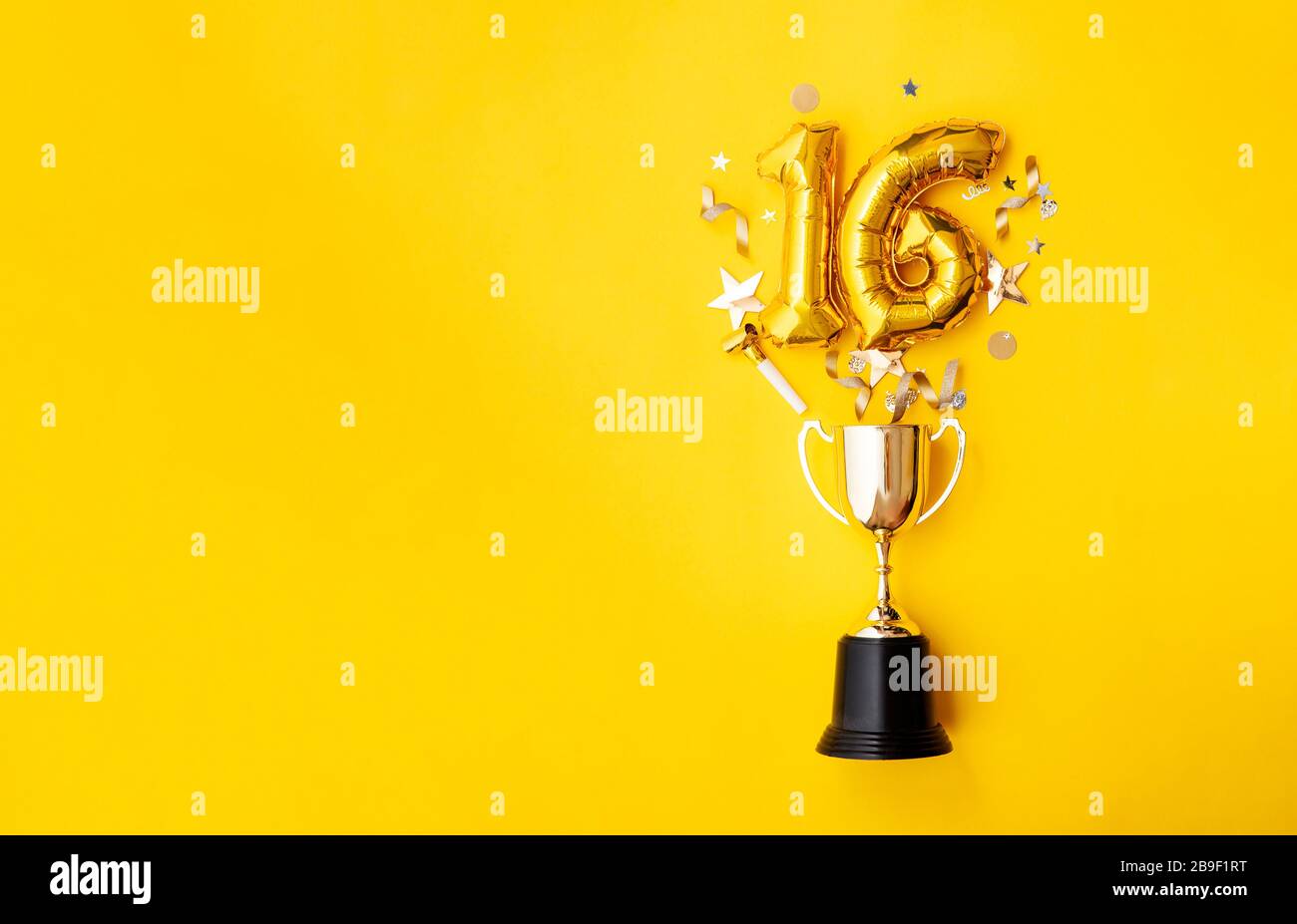 Number 16 gold anniversary celebration balloon exploding from a winning ...