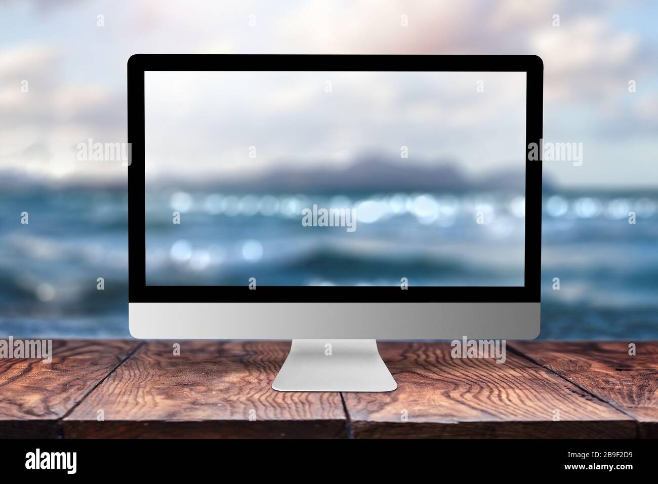 Computer display with blurred sea background Stock Photo - Alamy