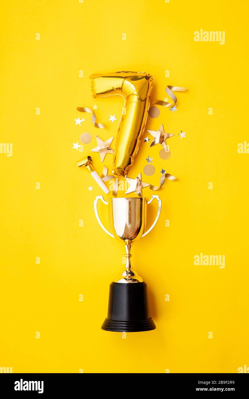 Number 7 gold anniversary celebration balloon exploding from a winning ...