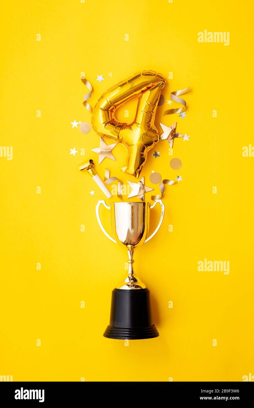 Number 4 gold anniversary celebration balloon exploding from a winning ...