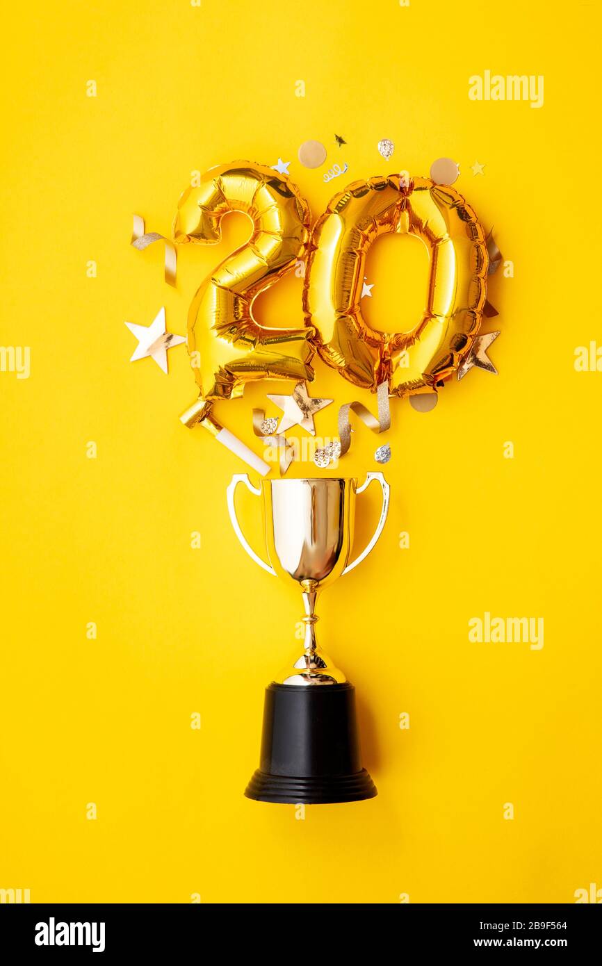 Number 20 gold anniversary celebration balloon exploding from a winning ...
