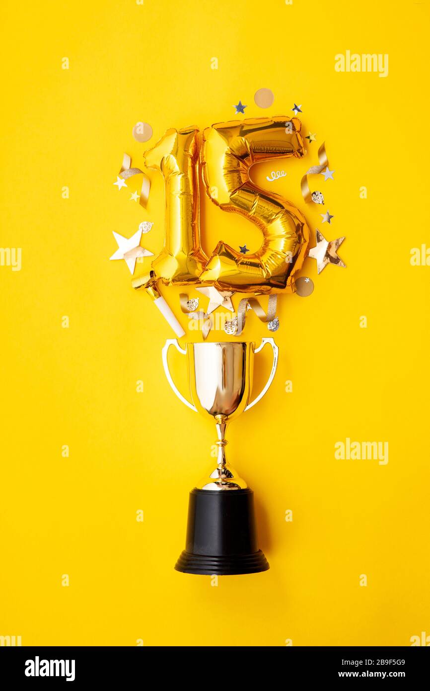 Number 15 gold anniversary celebration balloon exploding from a winning ...