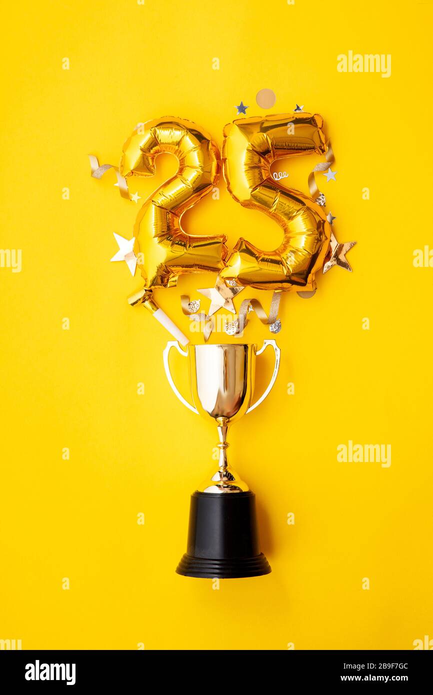 Number 25 gold anniversary celebration balloon exploding from a winning ...