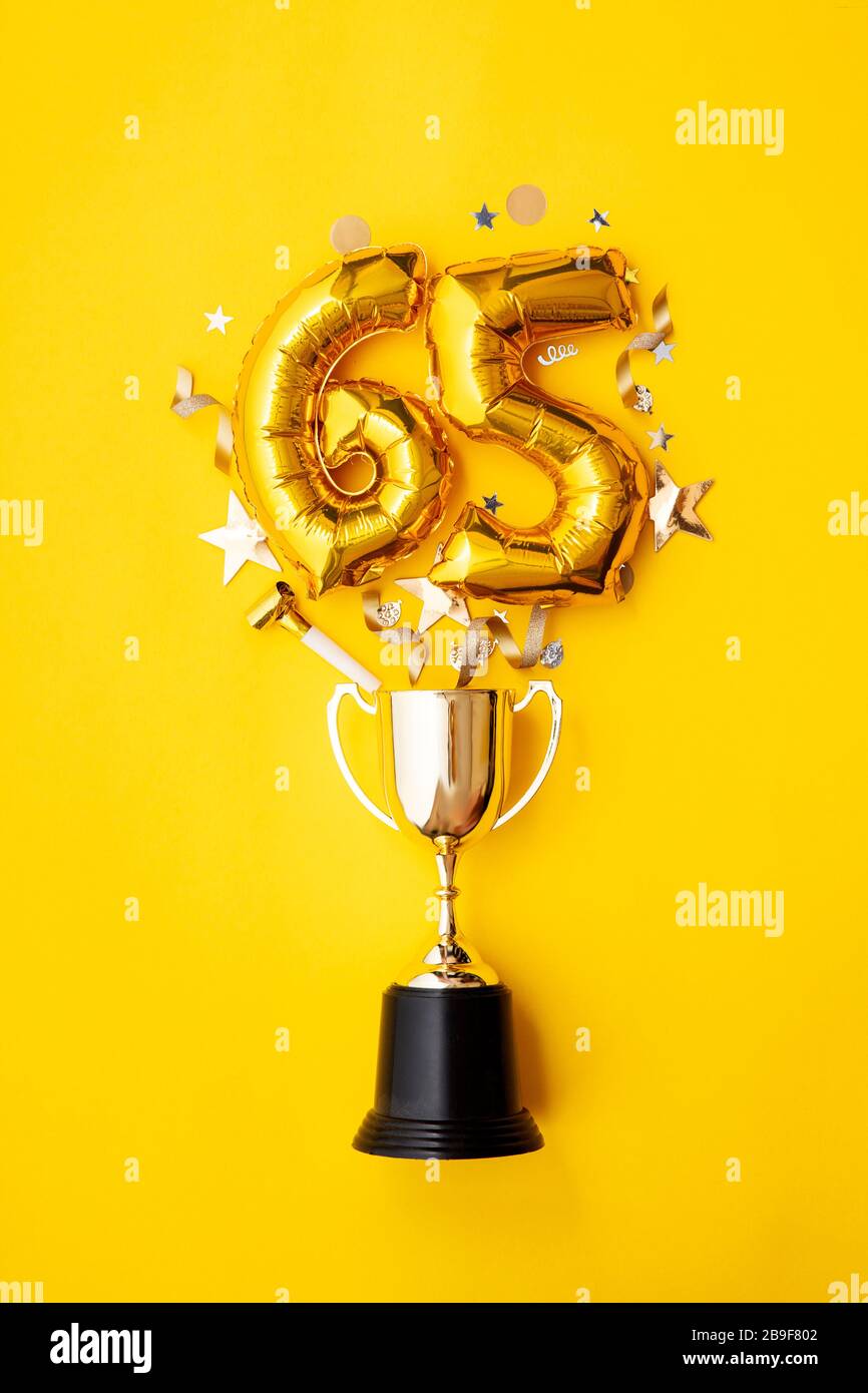 Number 65 gold anniversary celebration balloon exploding from a winning ...